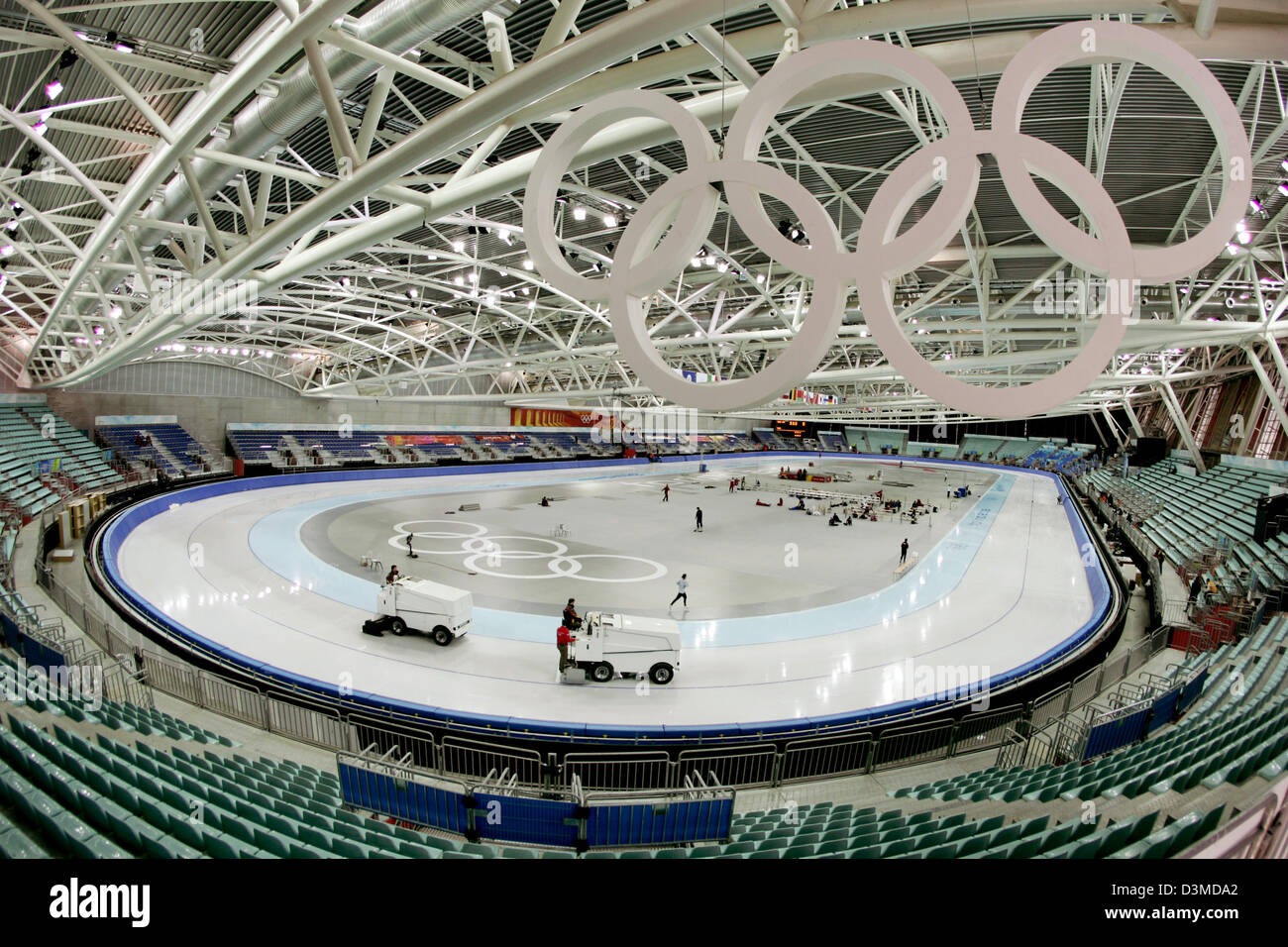 Ice machines prepare the ice of the Olympic speed skating rink in Turin ...
