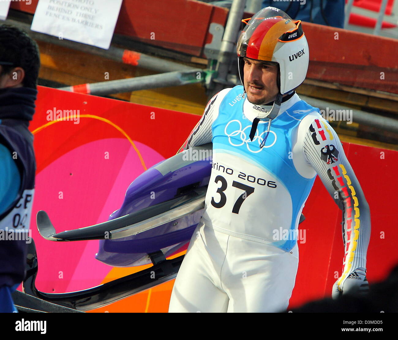 German luger and three-time Olympic winner Georg Hackl, carries his ...