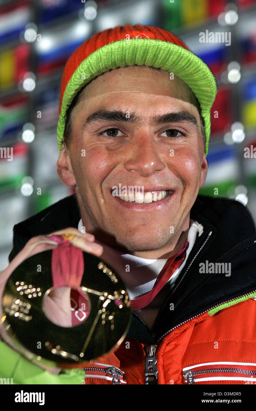 The German biathletes Michael Greis poses with his medal after the ...
