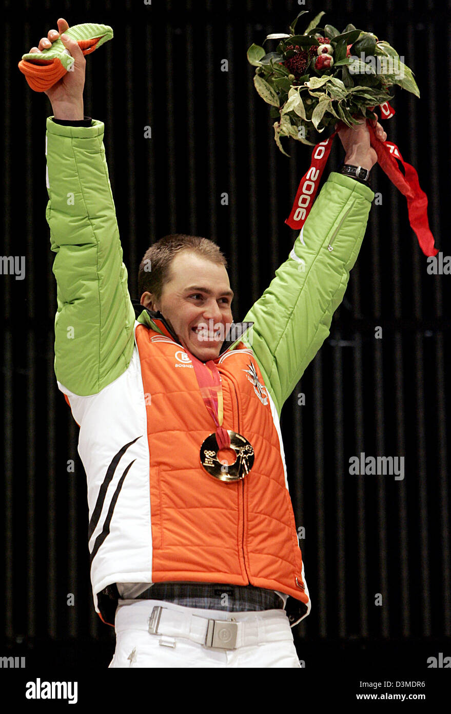 The German biathletes Michael Greis cheeres with his medal after the ...