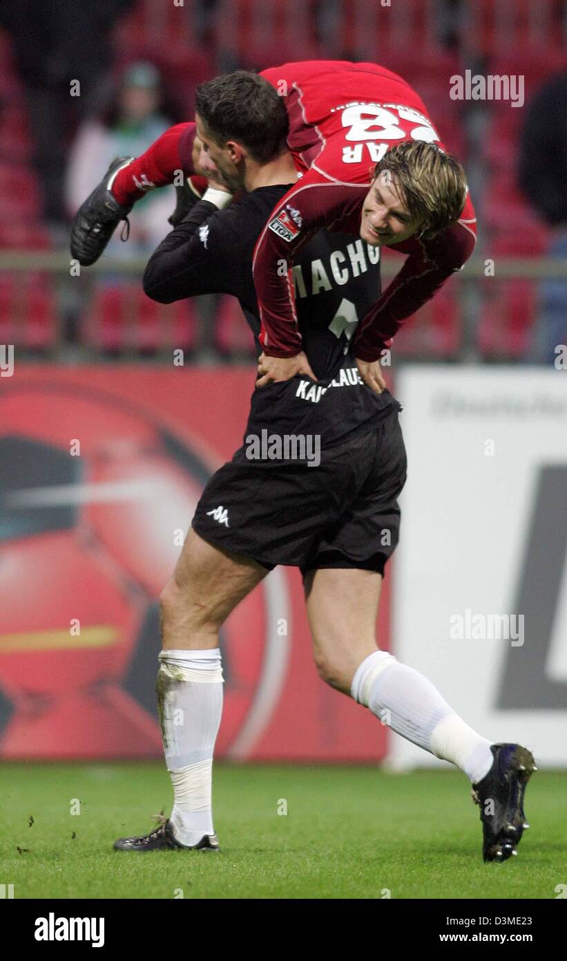 Kaiserslautern's goalkeeper carries his teammate Daniel Halfar on his ...