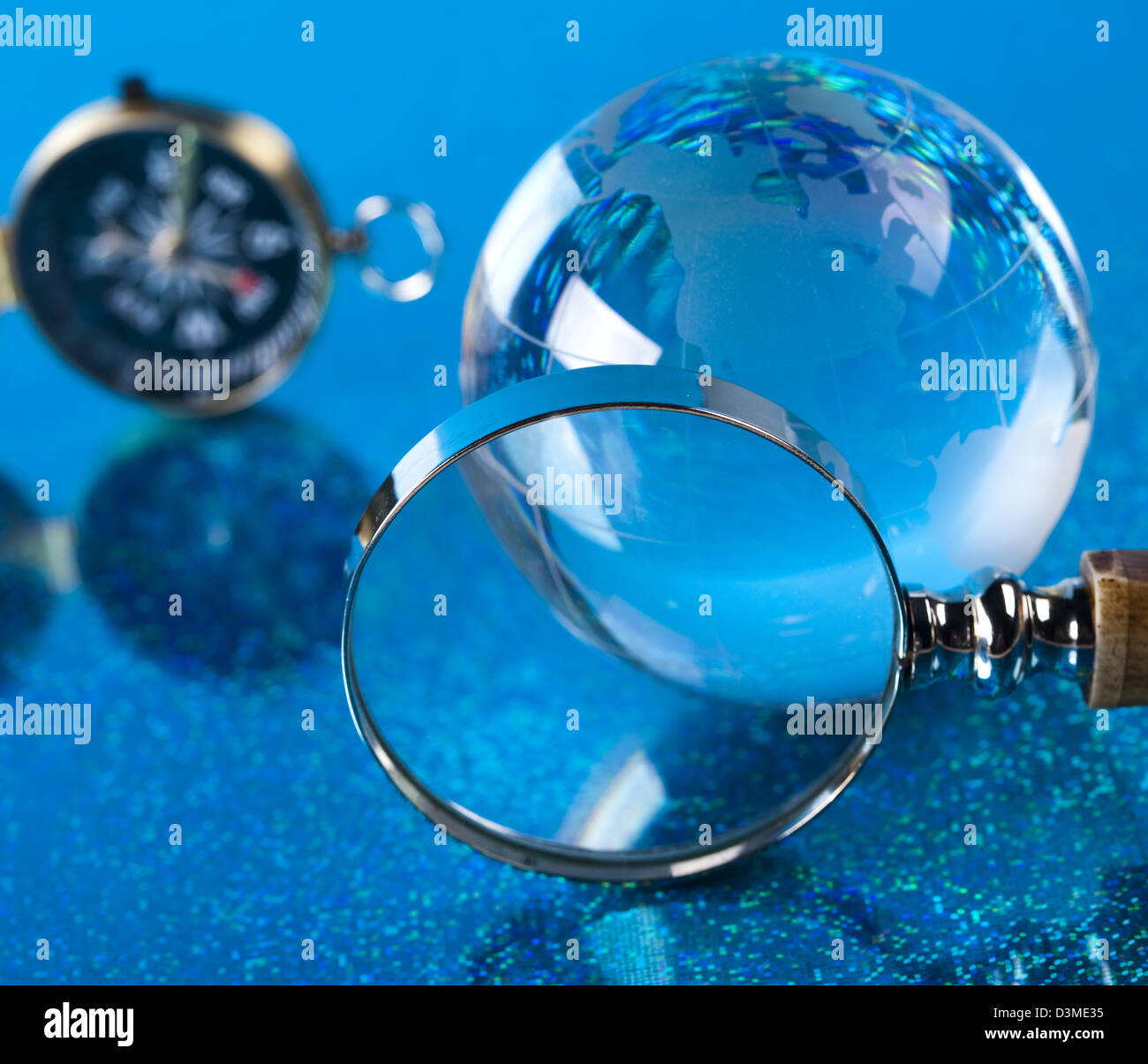 Magnifying glass, Compass and globe Stock Photo - Alamy