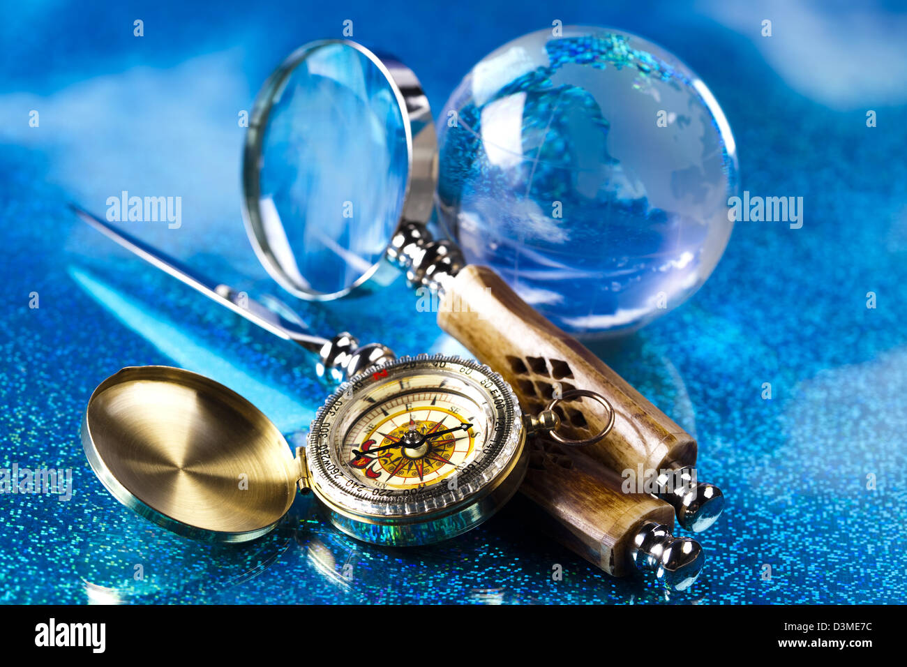 Magnifying glass, Compass and globe Stock Photo - Alamy