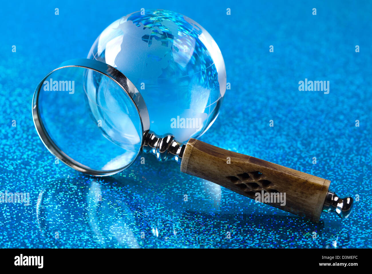 Globe and Magnifying glass Stock Photo - Alamy