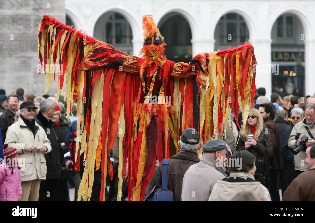 A fire bird wearing a Venetian carnival costume spreads the wings in ...