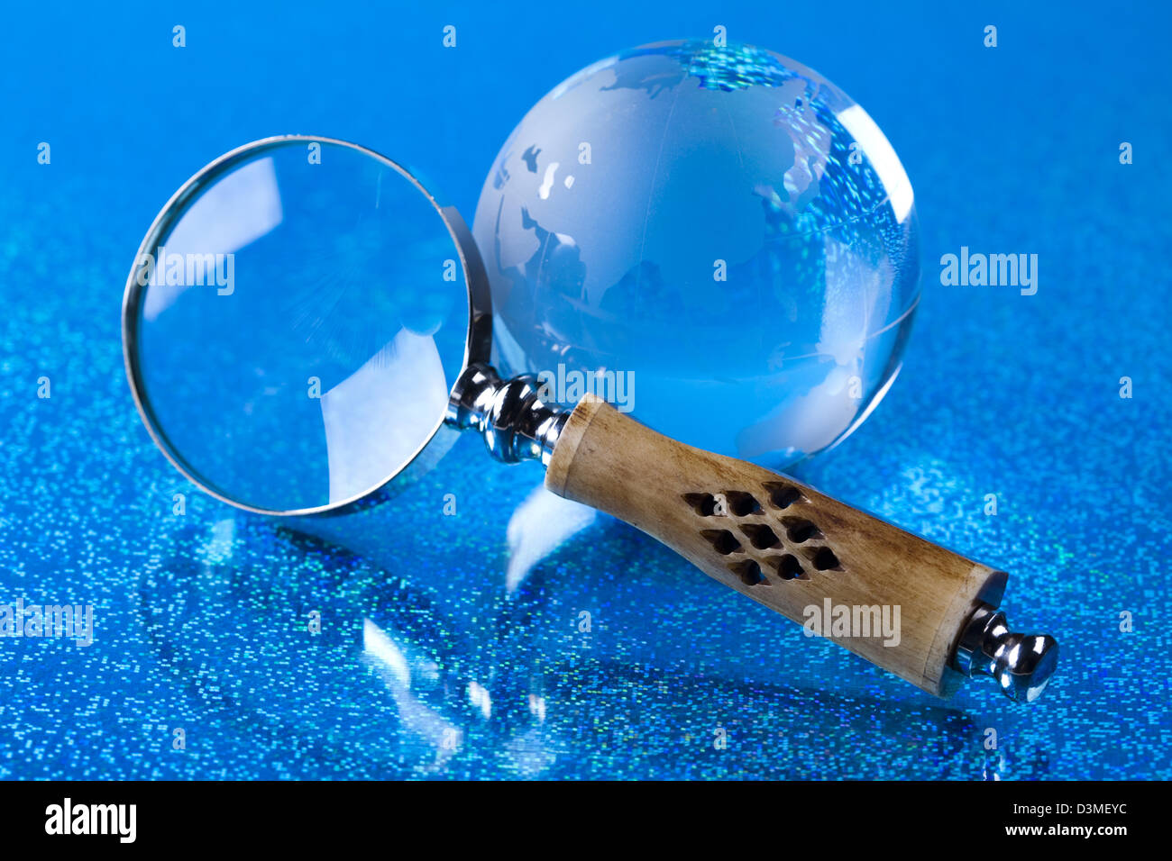 Globe and Magnifying glass Stock Photo - Alamy
