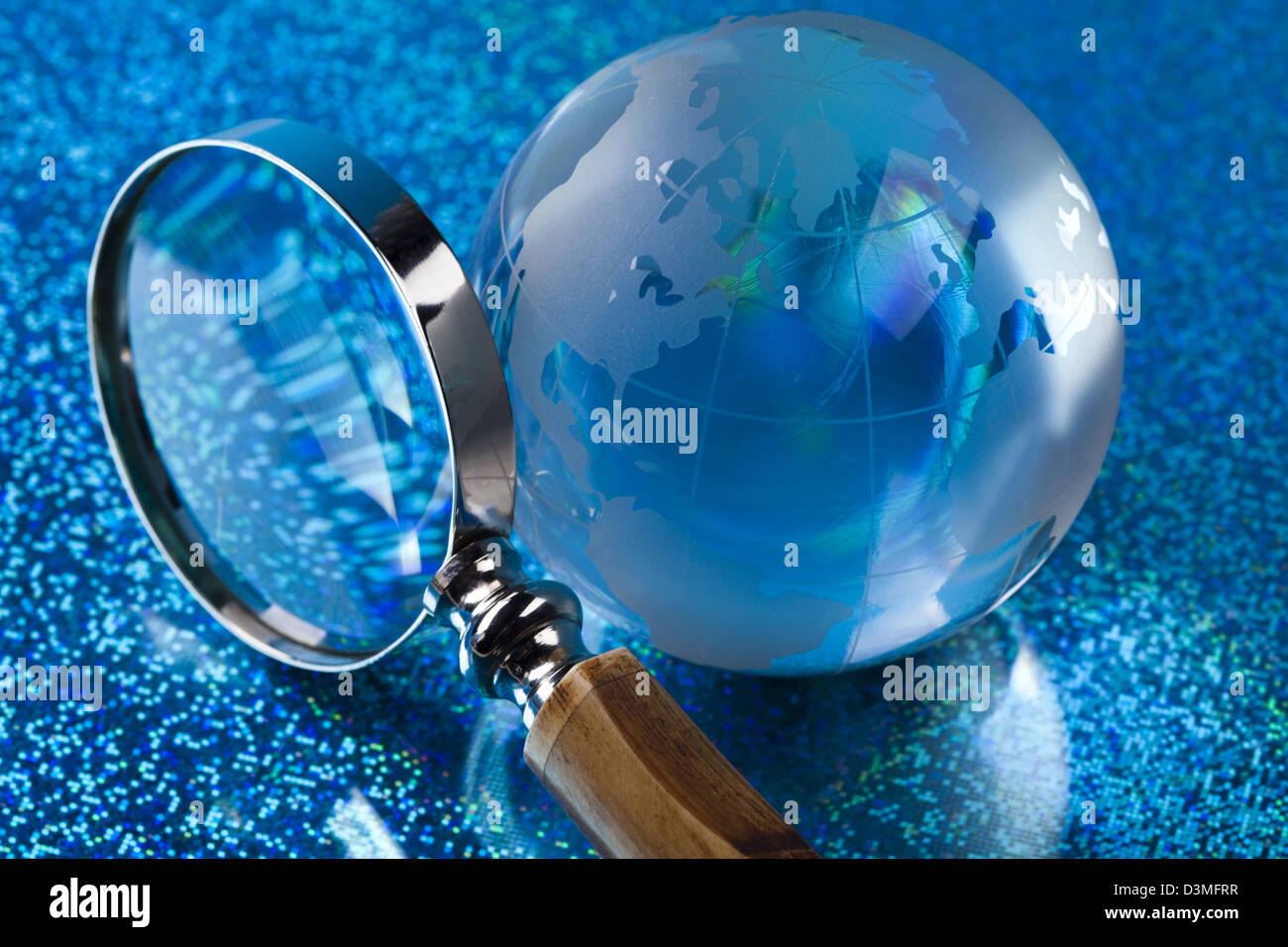 Globe and Magnifying glass Stock Photo - Alamy