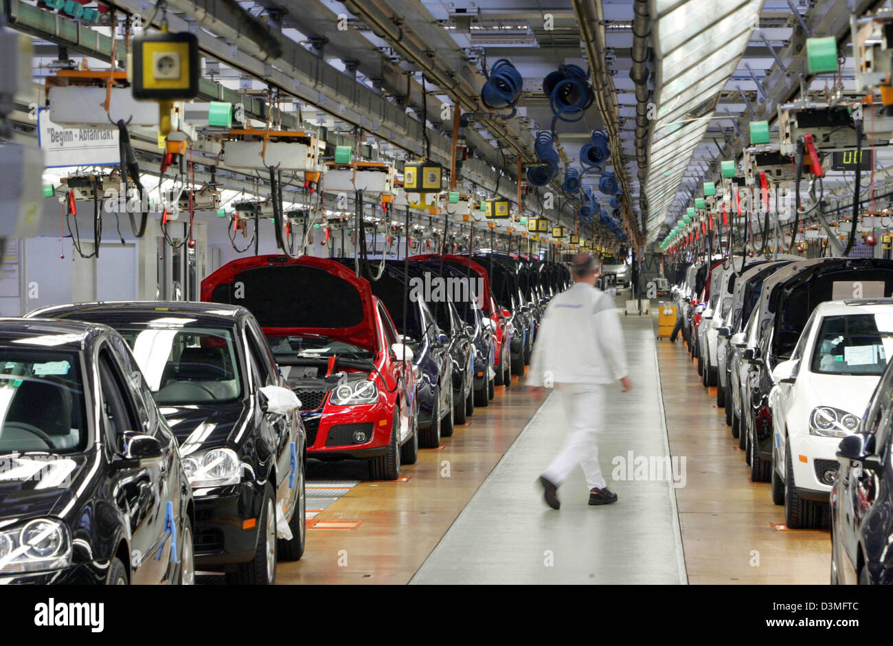 An employee of Volkswagen (VW) takes a break at an assembly line in ...