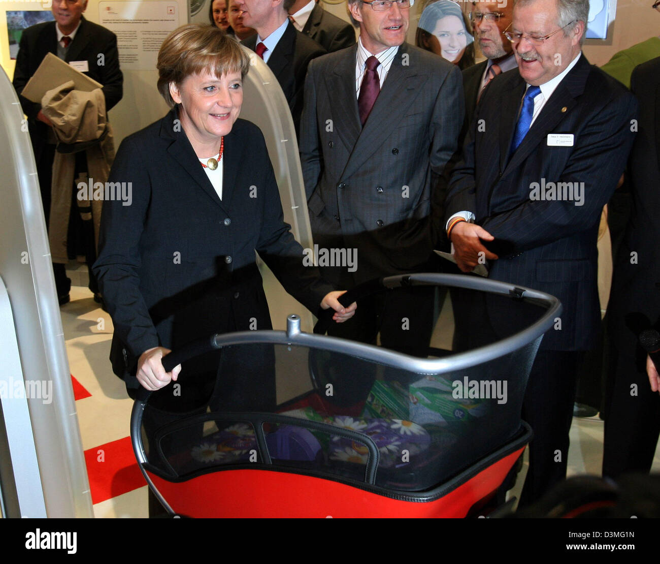German Chancellor Angela Merkel tests a Metro Group supermarket trolley ...