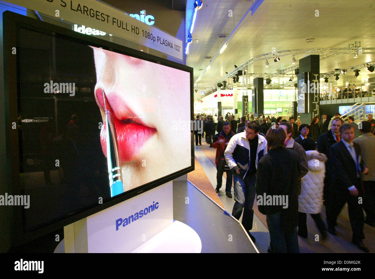 Visitors pass by the world biggest plasma screen by Panasonic at the leading fair for computing ...