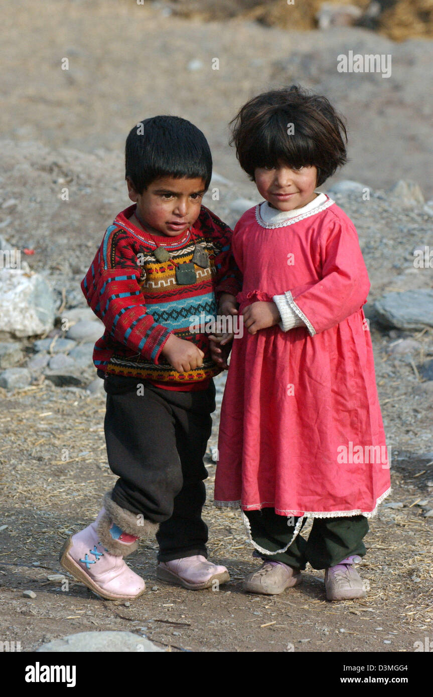 Two little children hold hands at a refugee camp near the city of ...