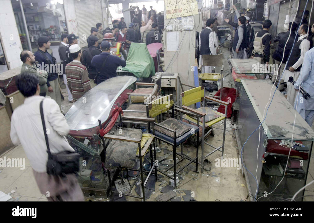 People gather at site and wreckage of destroyed shops seen after a bomb ...