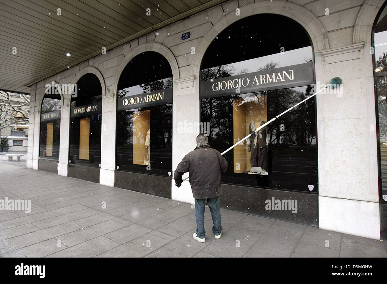 The picture shows the cleaning of the storefront of a store of luxury ...