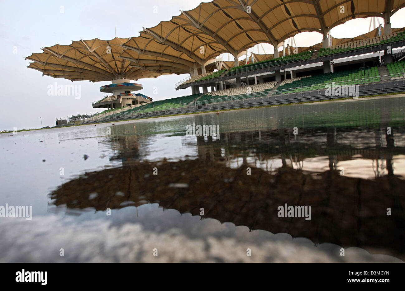 The Grand Stands are reflected on the rain flooded Formula One ...