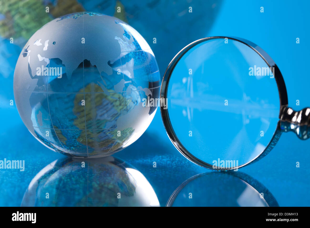 Globe and Magnifying glass Stock Photo - Alamy