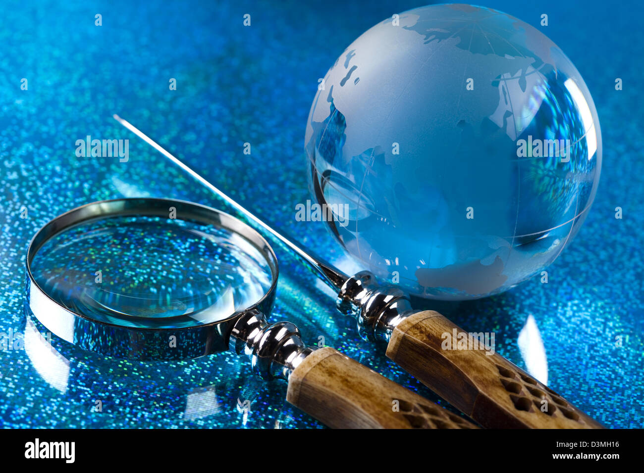 Magnifying glass and globe Stock Photo - Alamy