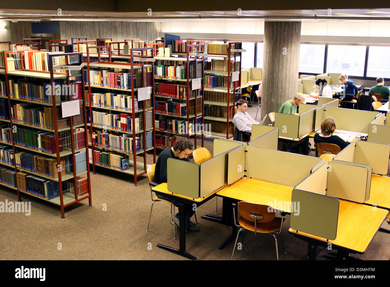 University students sit behind reading cubicals and study at the ...