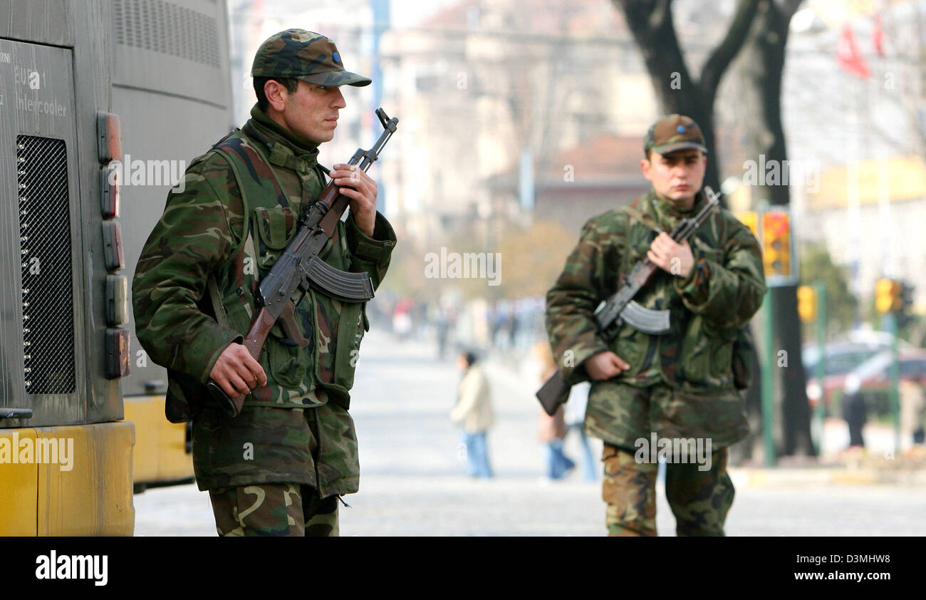 Two soldiers of the Turkish army guard the travel coaches of a tourist ...