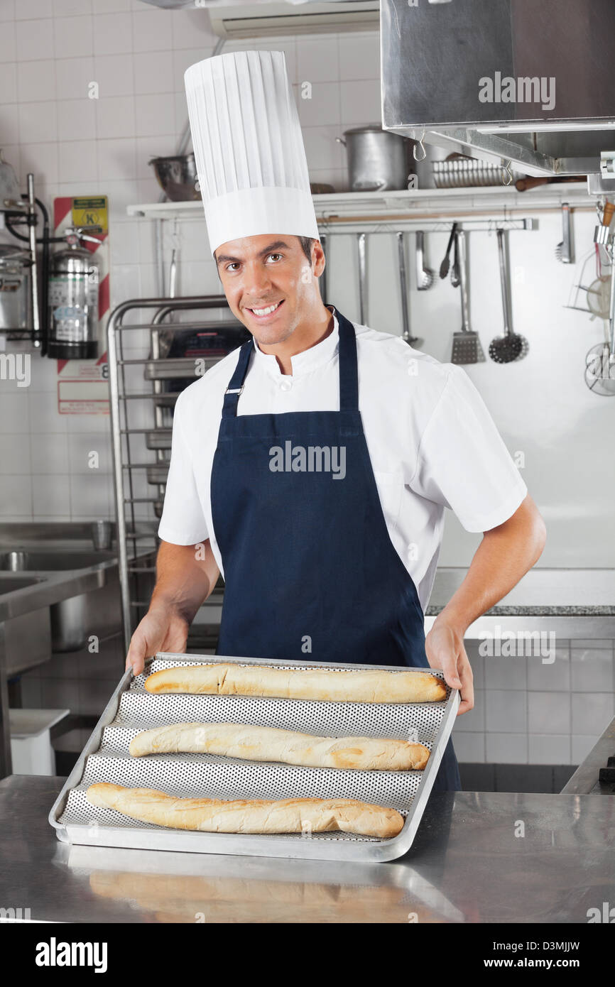 Happy baker presenting loaf bread hi-res stock photography and images ...