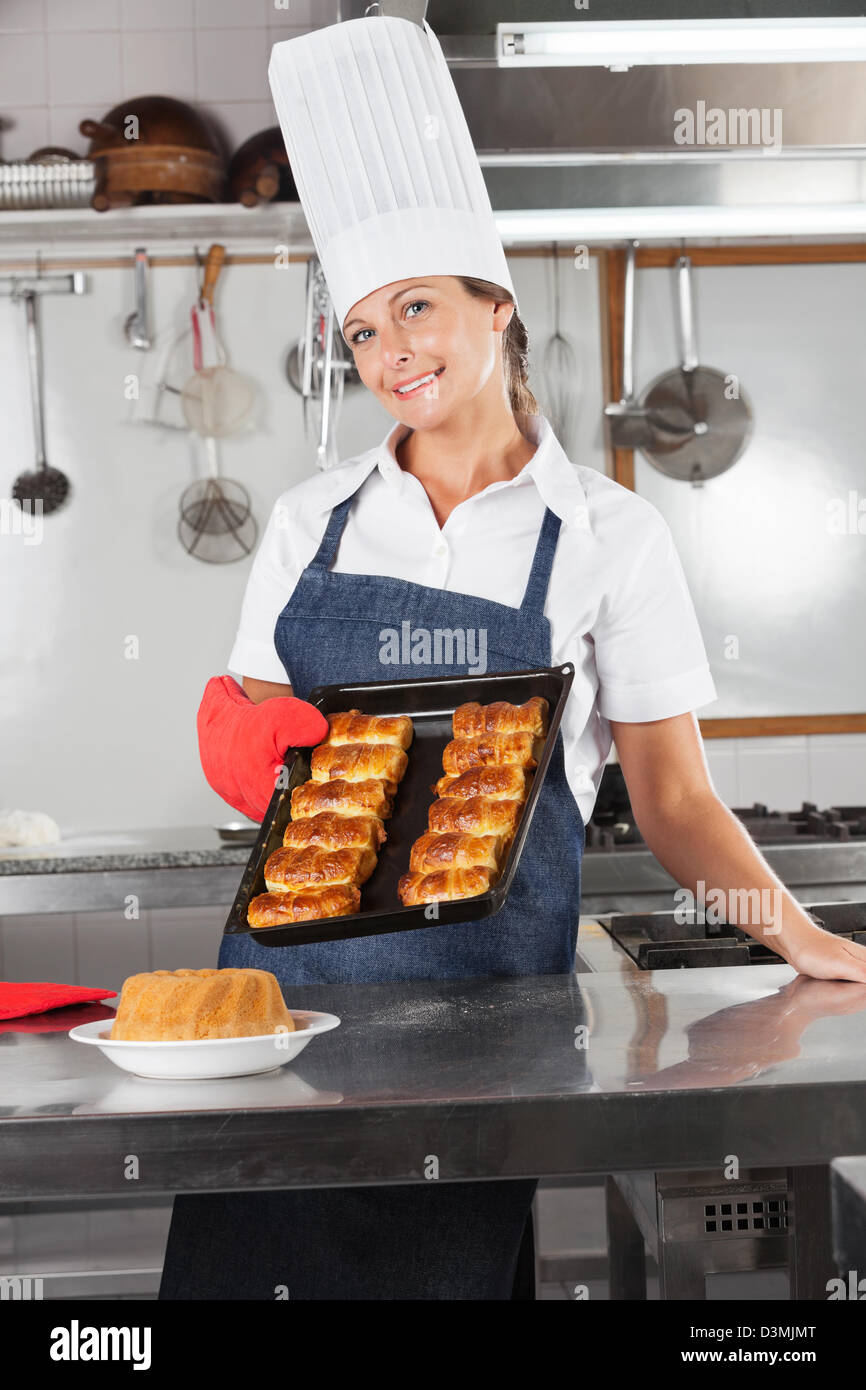 Female Chef Holding Tray Of Baked Breads Stock Photo - Alamy