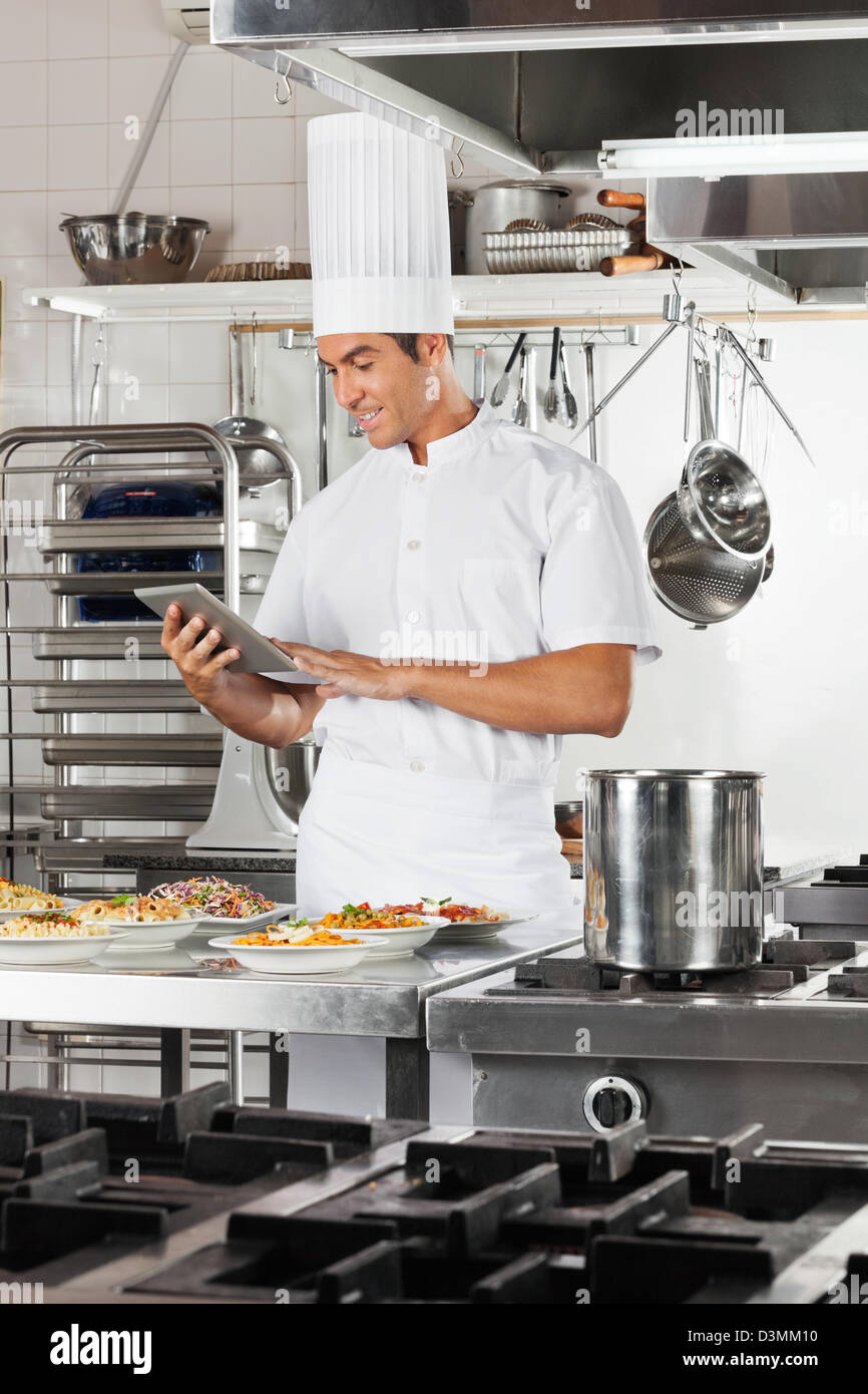 Professional chef using tablet computer hi-res stock photography and ...