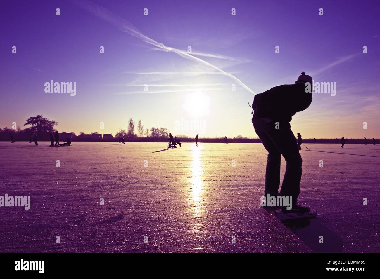 Ice skating at sunset in the countryside from the Netherlands Stock ...
