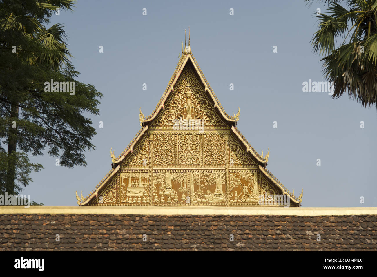 The heavily ornamented gable-end of a temple roof looms over an old ...
