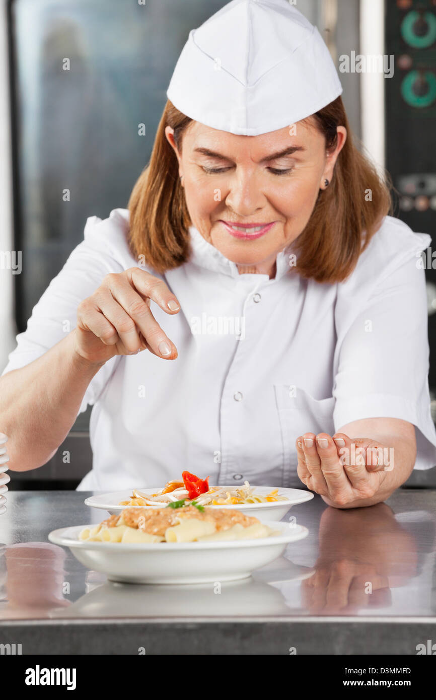 Woman adding garnish dish hi-res stock photography and images - Alamy