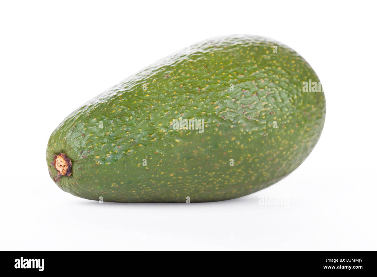 Whole avocado and slice closeup on white Stock Photo - Alamy