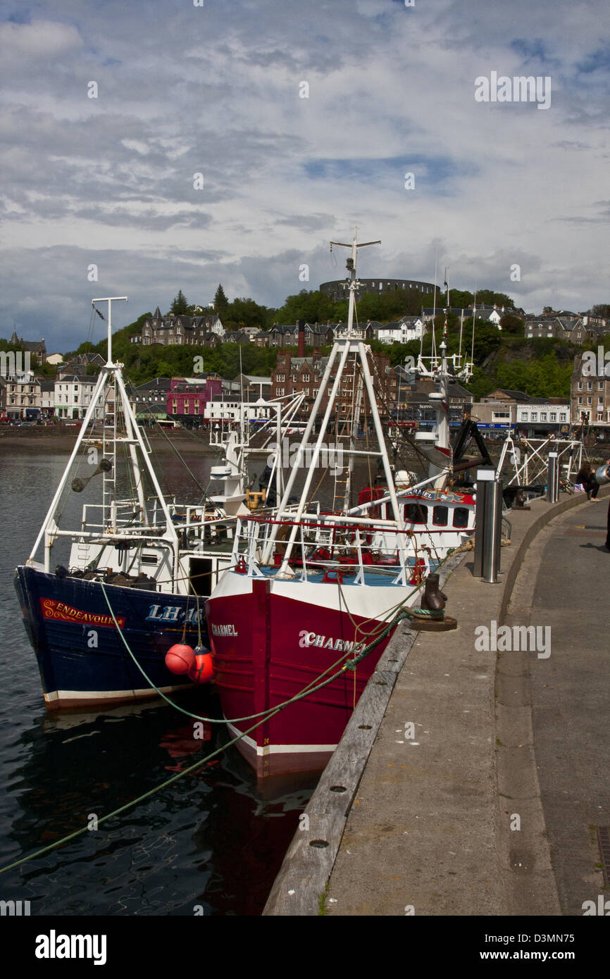 Oban, Scotland, fishing boats at quayside, town wharf with McCraig's ...