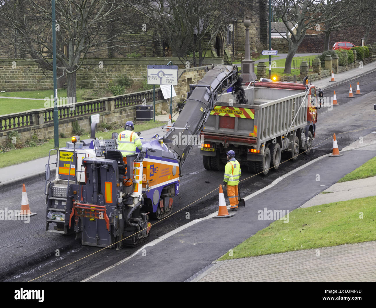 A small road planing machine in action on a road resurfacing job Stock ...