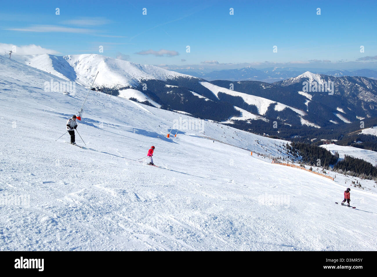Skiers on a slope and view on Chopok peak in Jasna Low Tatras, Slovakia ...
