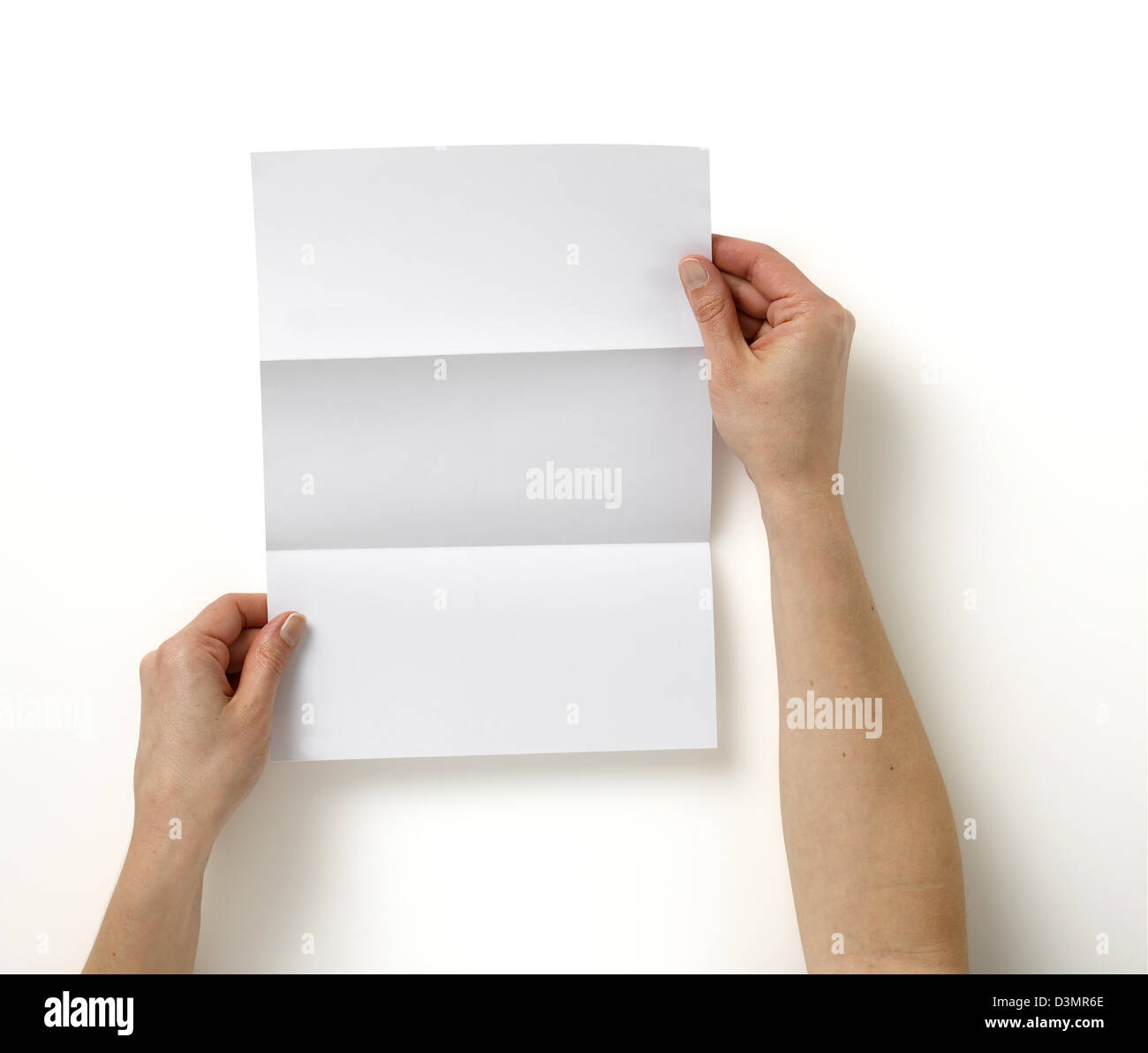 pair of hands holding folded blank A4 copy space letter with clipping ...