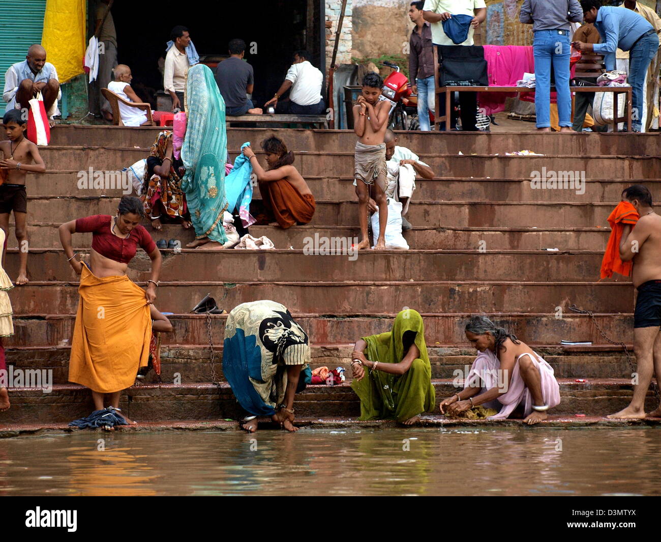 Morning Hindu Indian bathers along the ghats that line the Mandakini ...