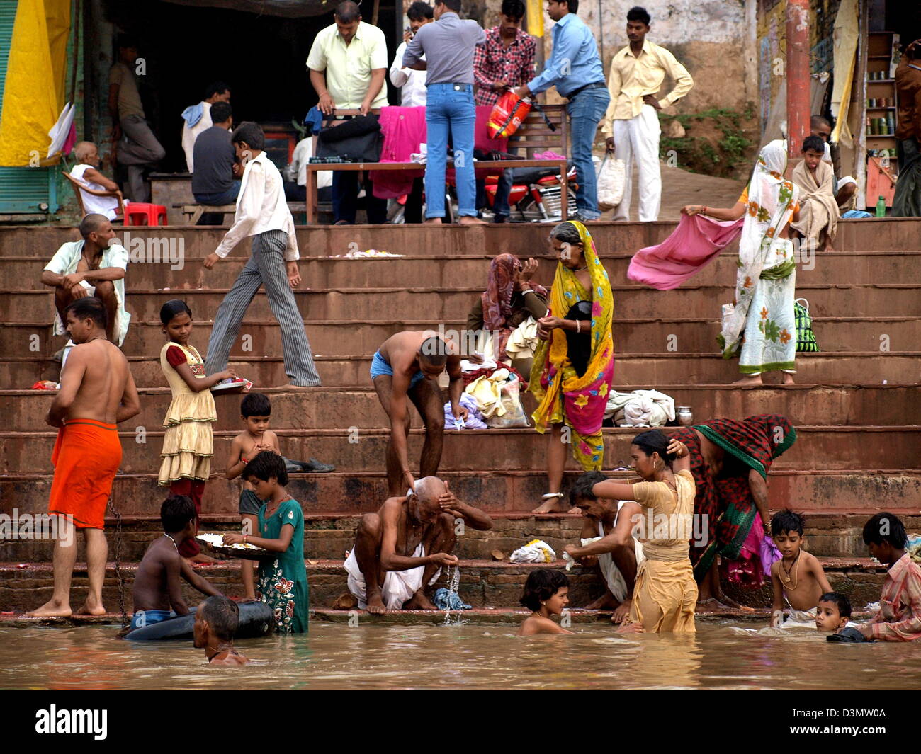 Morning Hindu Indian bathers along the ghats that line the Mandakini ...