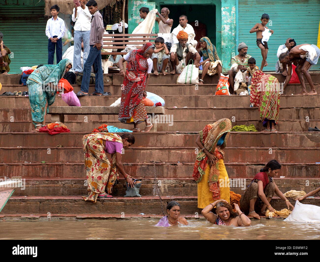 Morning Hindu Indian bathers along the ghats that line the Mandakini ...