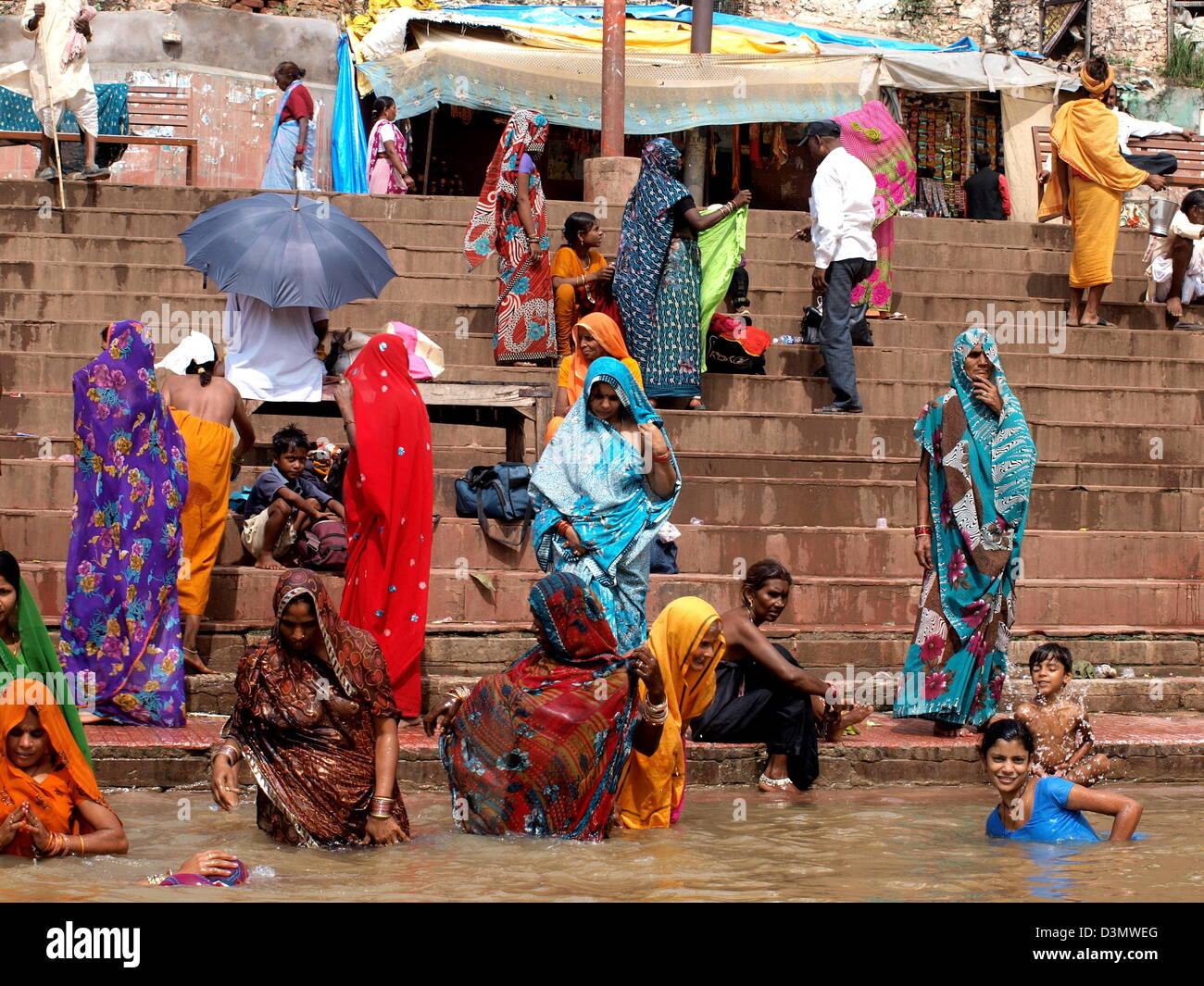 Morning Hindu Indian bathers along the ghats that line the Mandakini ...