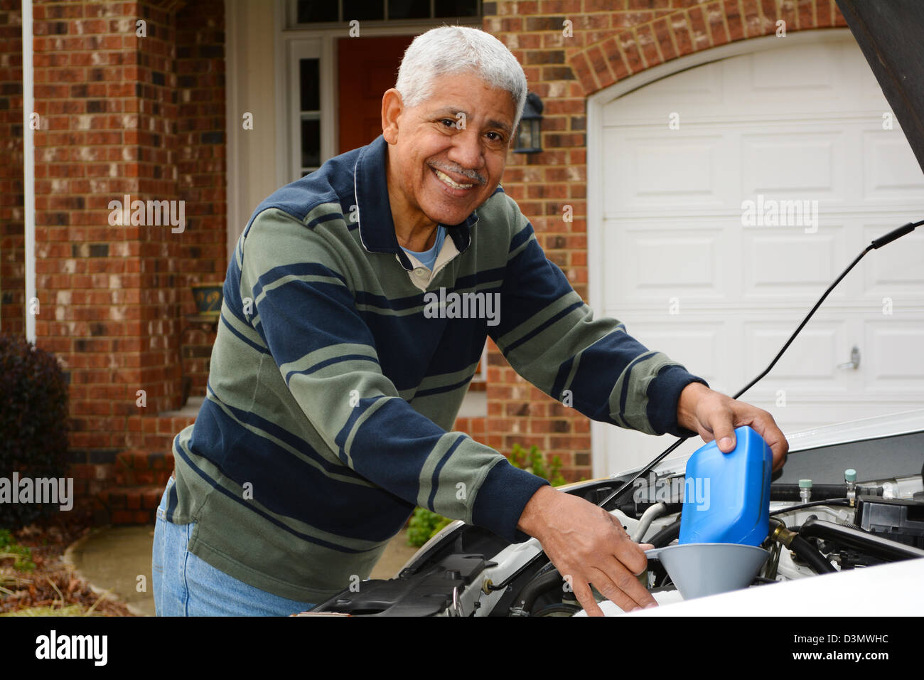 Mechanic working on a car in his driveway Stock Photo - Alamy