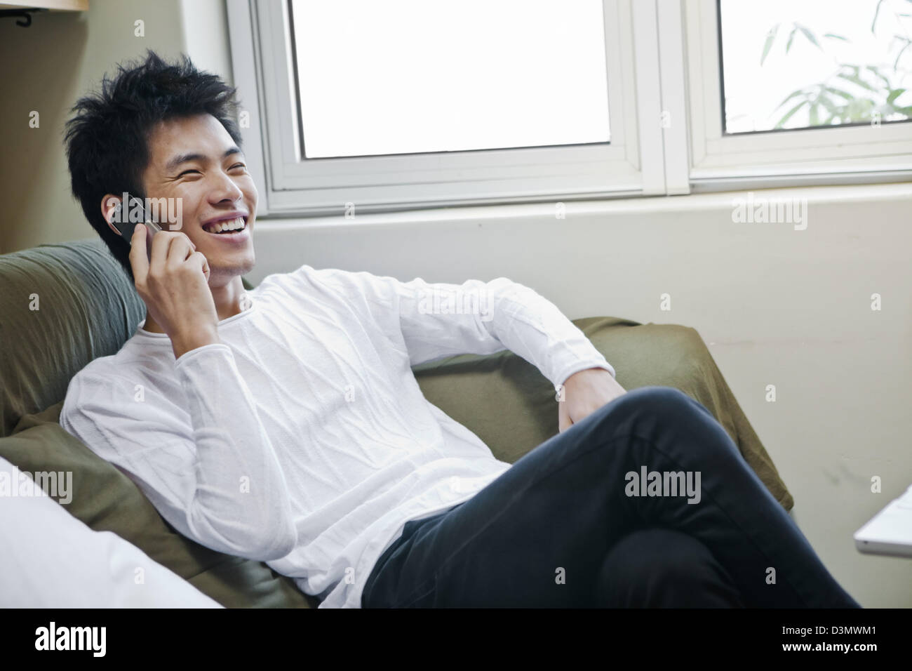Happy Young Chinese Man in Mobile Phone Call Conversation Stock Photo ...