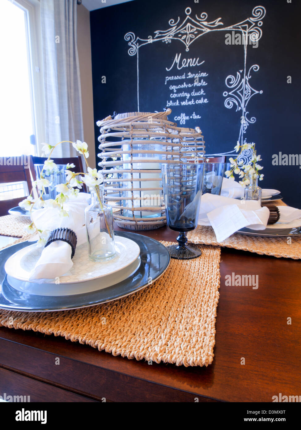 Modern dining room with table set for family dinner Stock Photo - Alamy