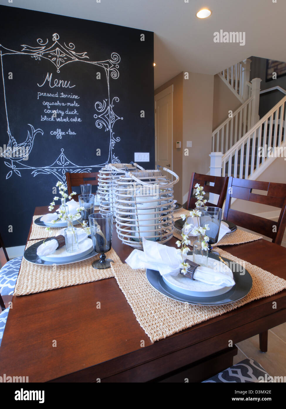 Modern dining room with table set for family dinner Stock Photo - Alamy