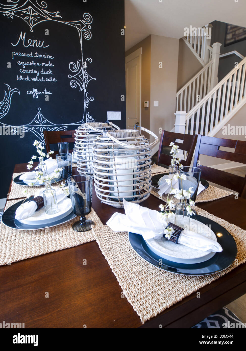 Modern dining room with table set for family dinner Stock Photo - Alamy