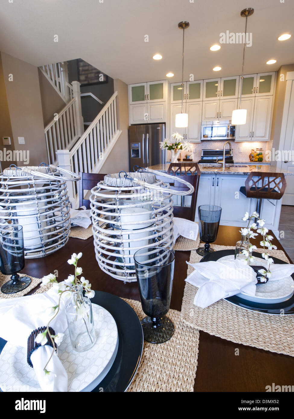 Modern dining room with table set for family dinner Stock Photo - Alamy