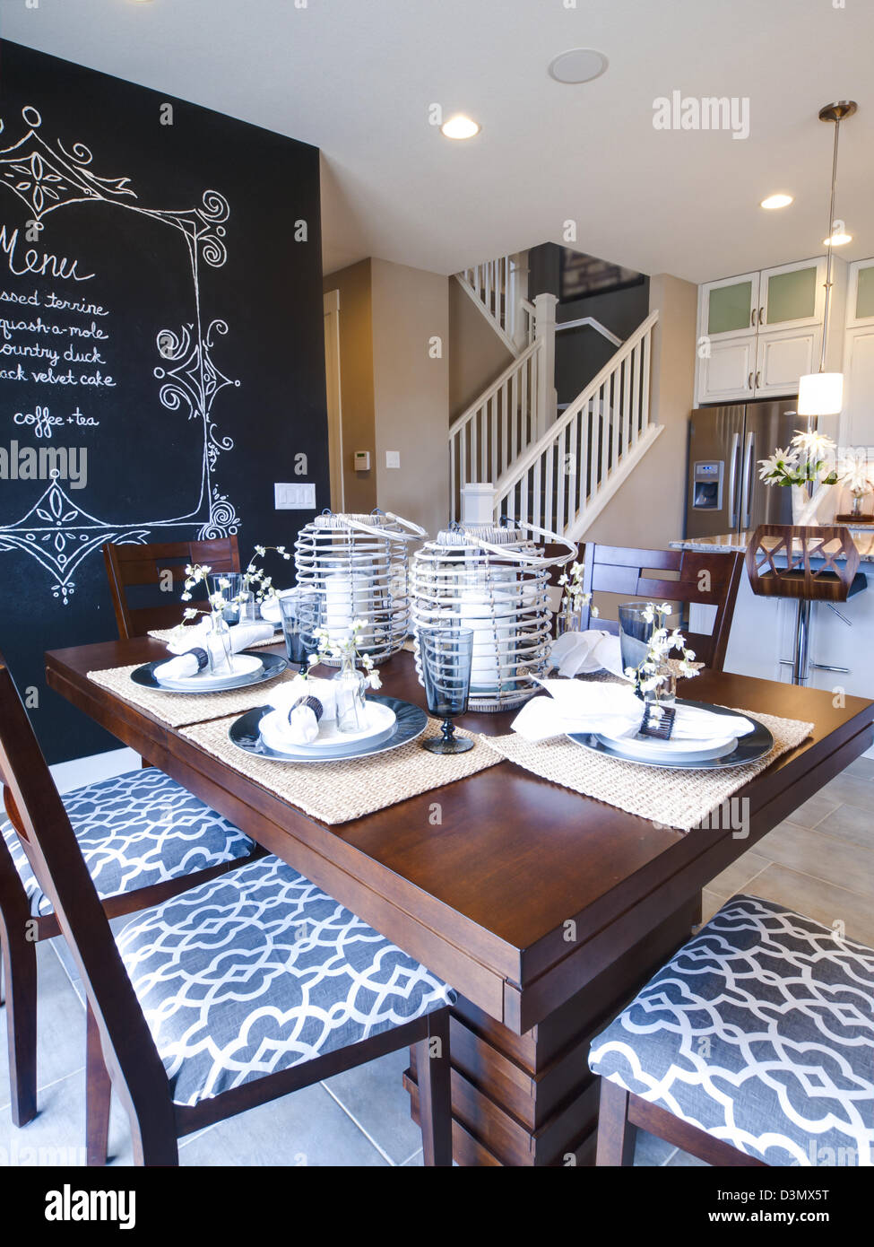 Modern dining room with table set for family dinner Stock Photo - Alamy
