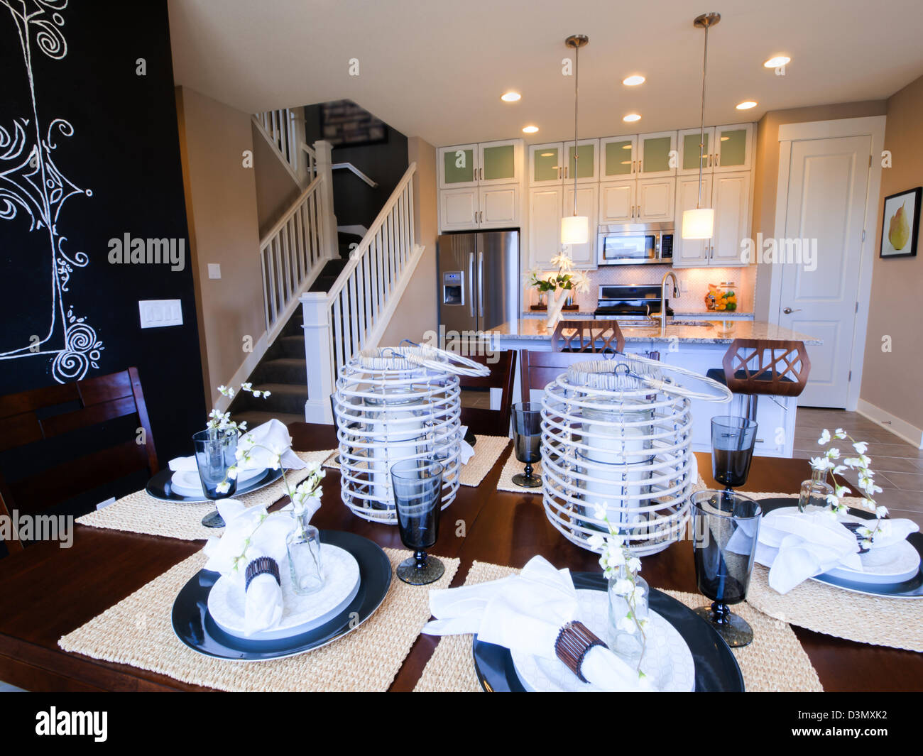 Modern dining room with table set for family dinner Stock Photo - Alamy