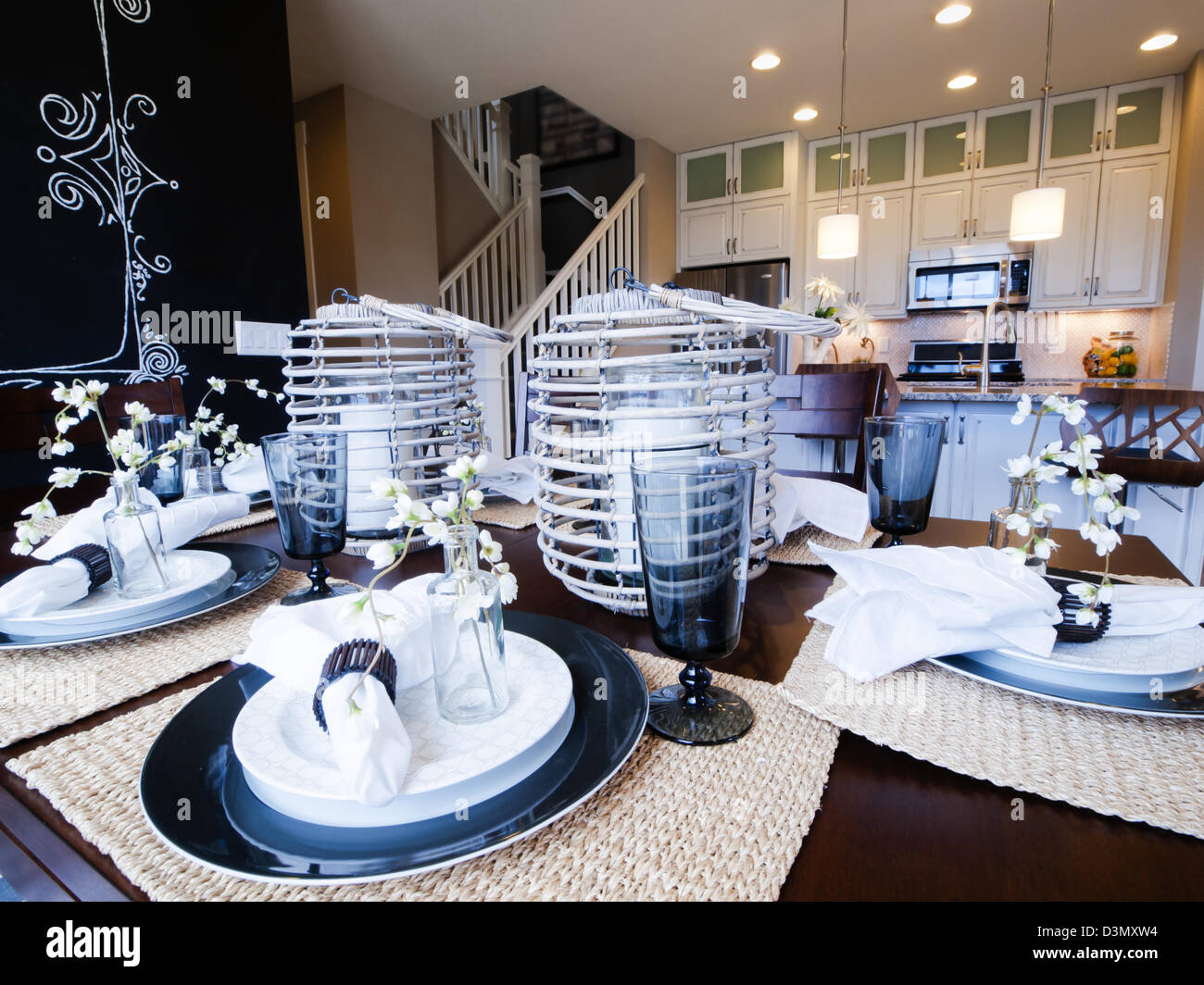 Modern dining room with table set for family dinner Stock Photo - Alamy