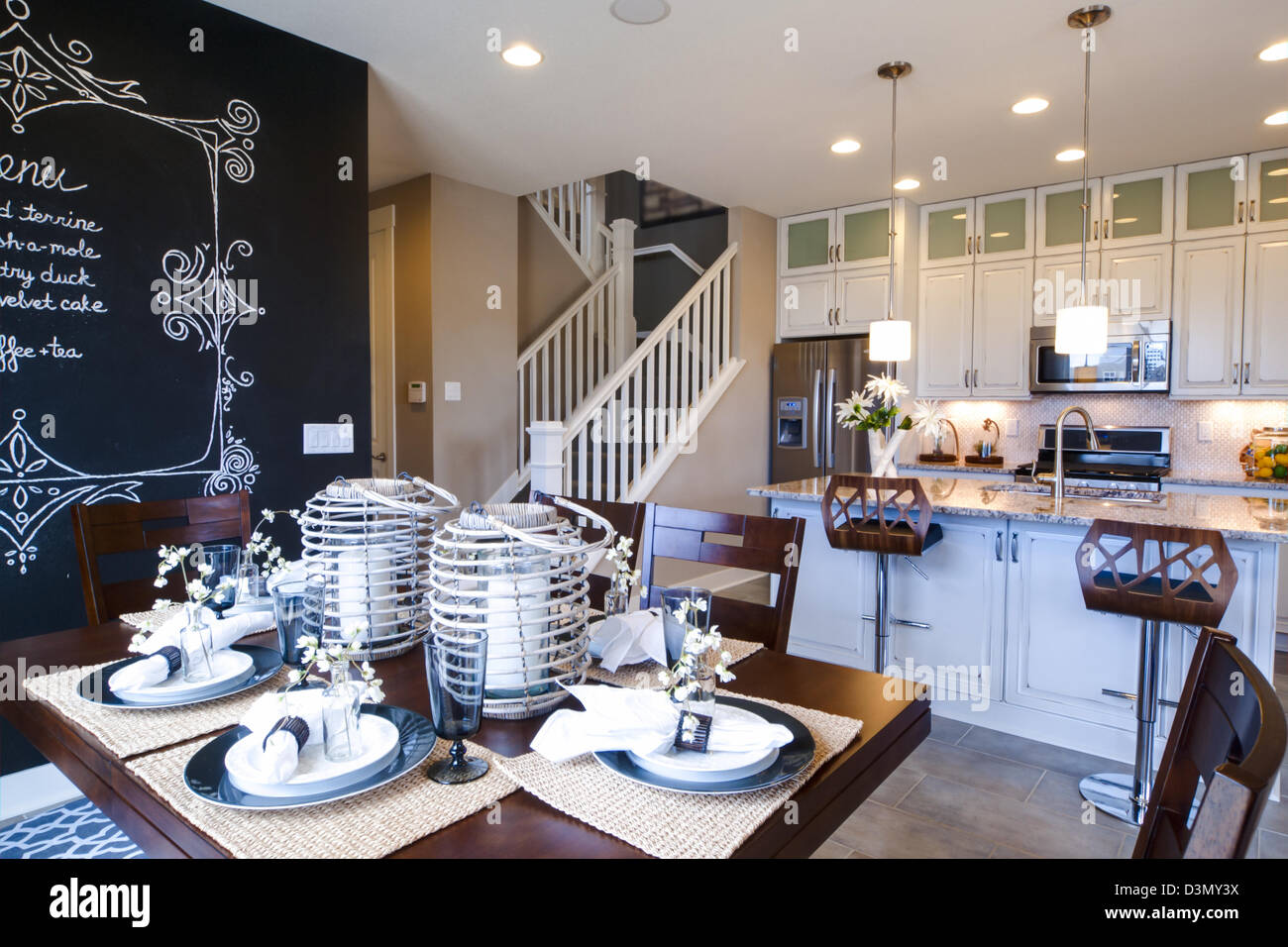 Modern dining room with table set for family dinner Stock Photo - Alamy