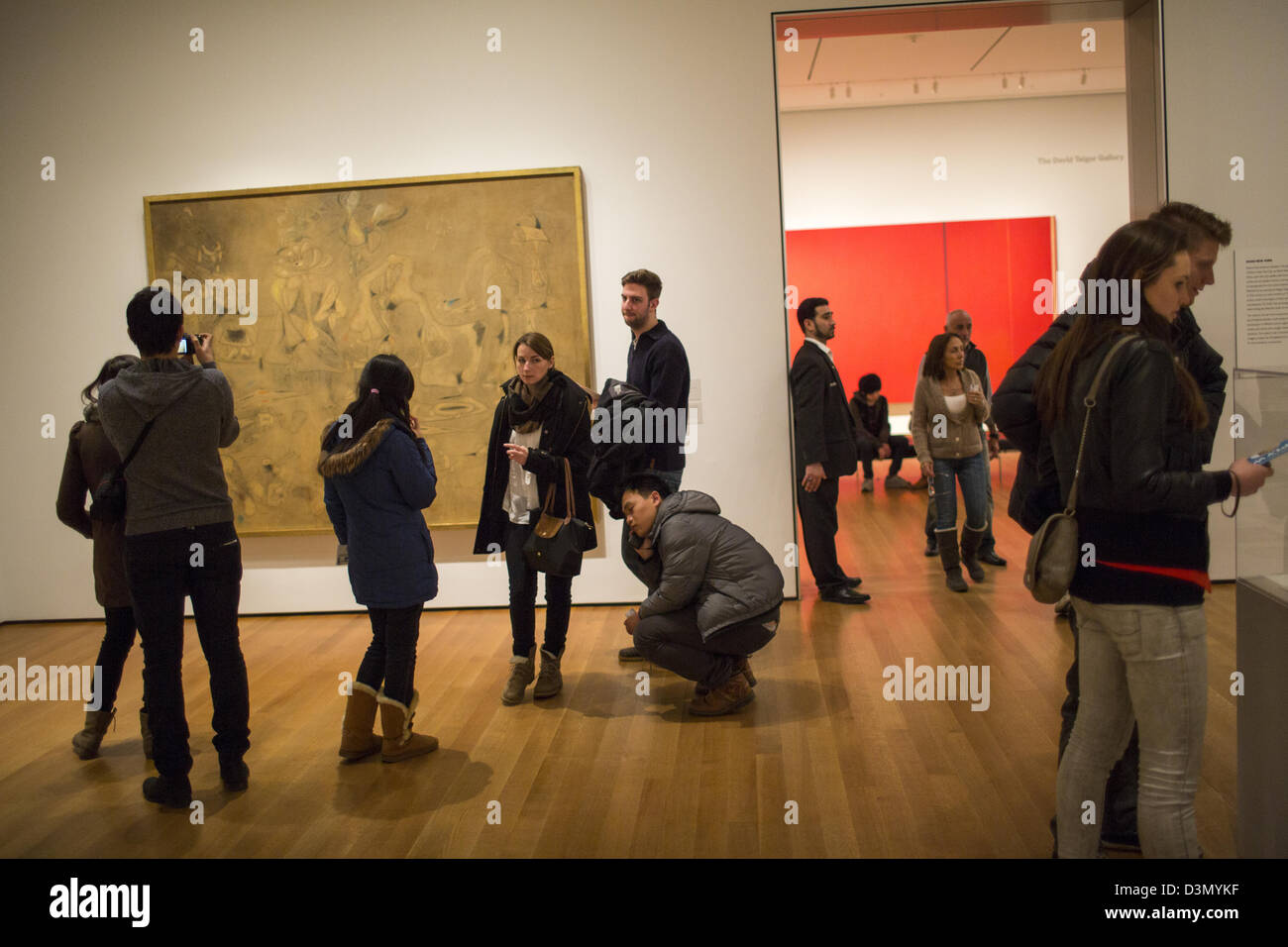 Viewers walk through a gallery of a modern art exhibit at the Museum of ...