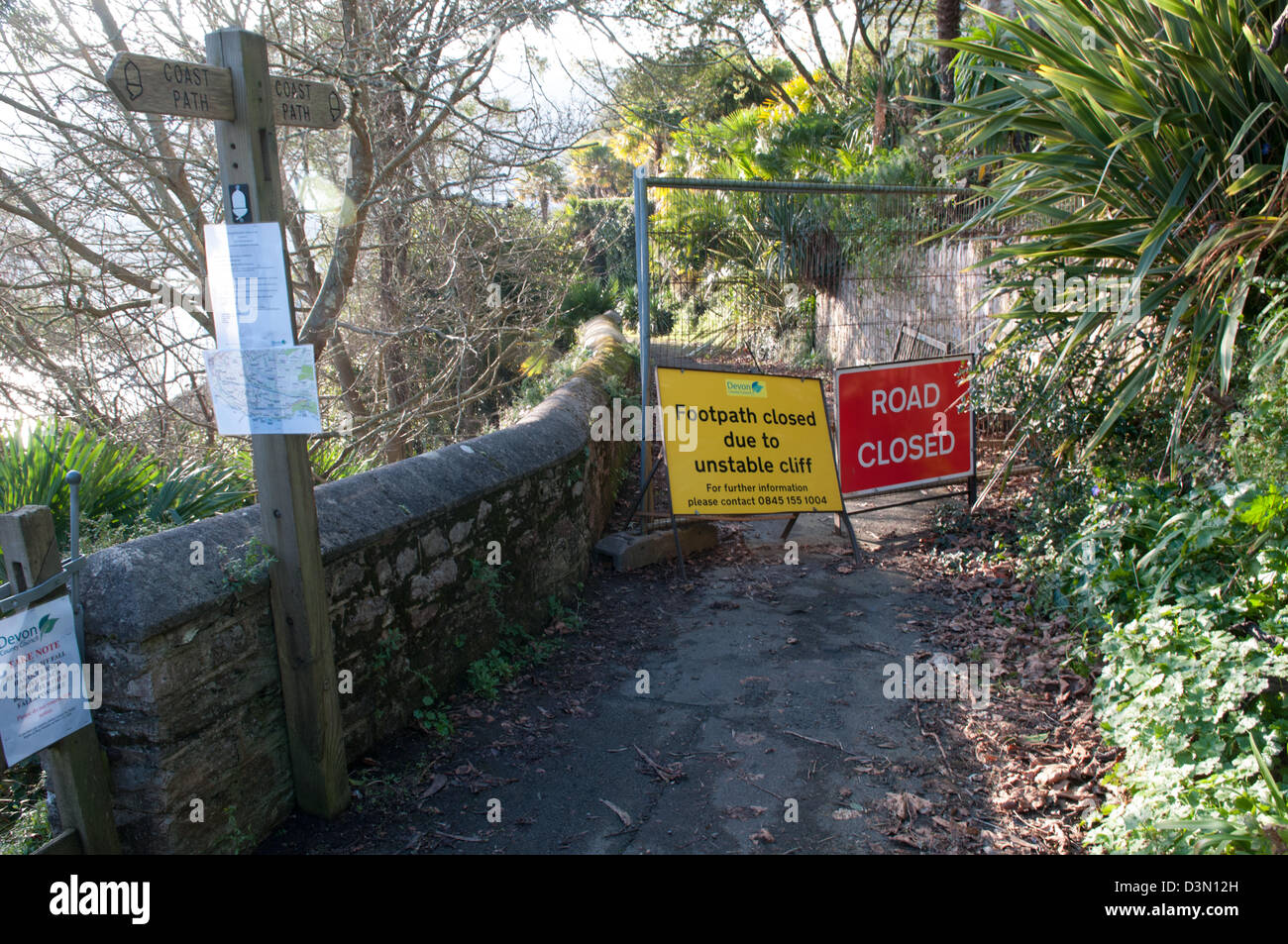 Traffic signs warning of a footpath and road closure due to an unstable ...