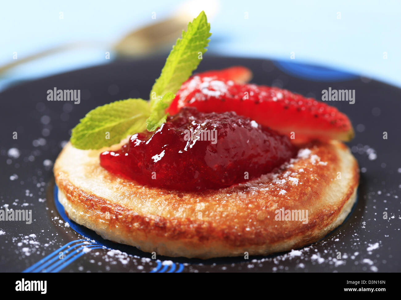 Pancake topped with strawberry jam Stock Photo - Alamy